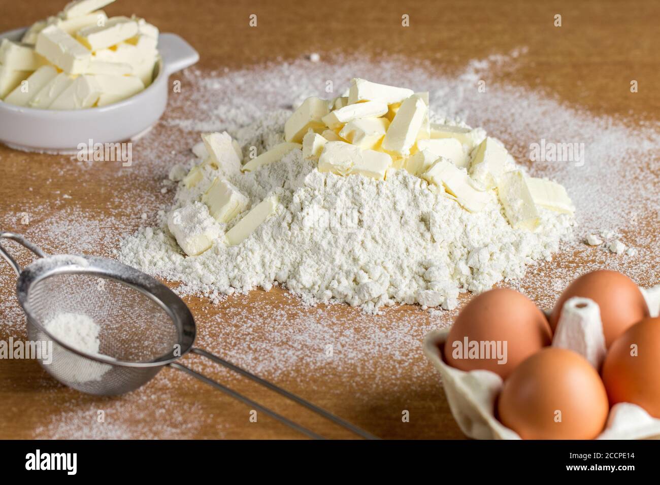 Ingredients for prepare dough on a wooden table-wheat flour, butter or ...