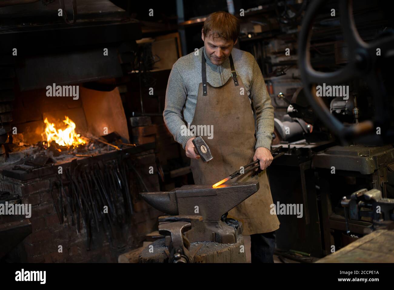 Blacksmith working on an anvil Stock Photo - Alamy