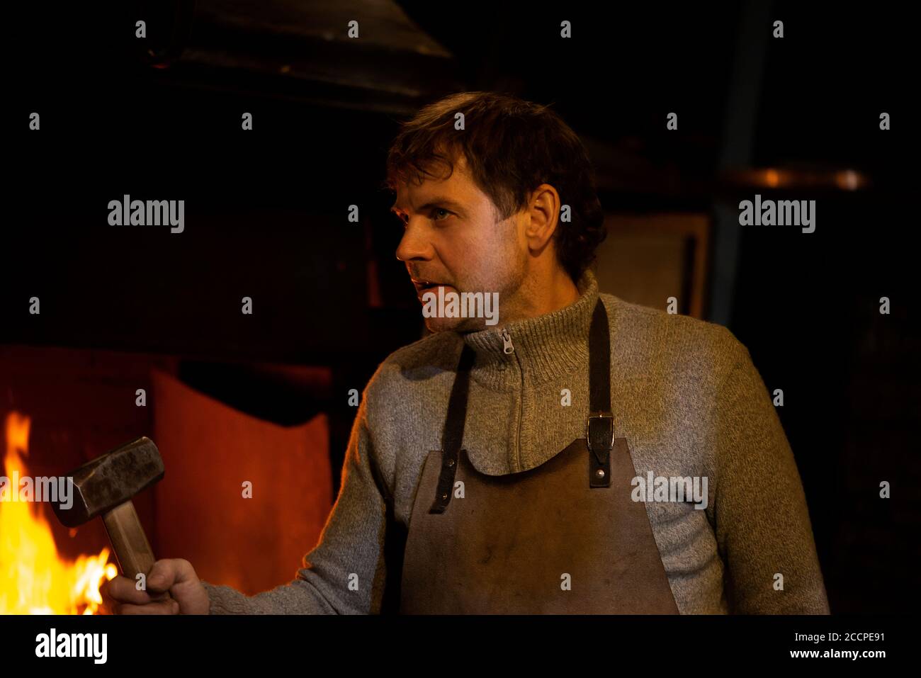 Portrait of blacksmith holding hammer Stock Photo - Alamy