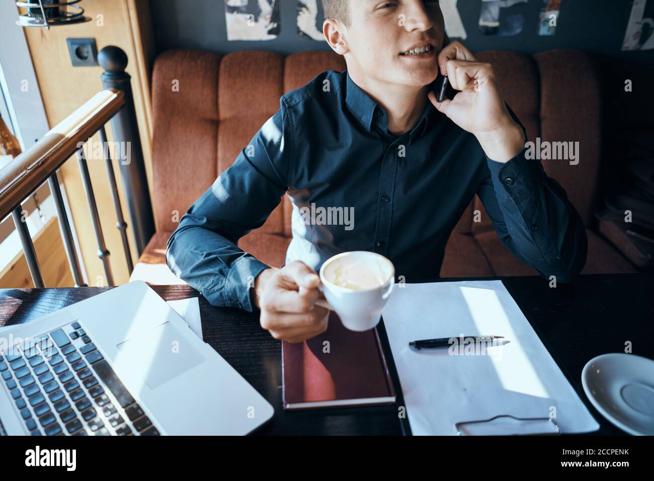 Business man with a cup of coffee in a cafe emotions work in the office ...
