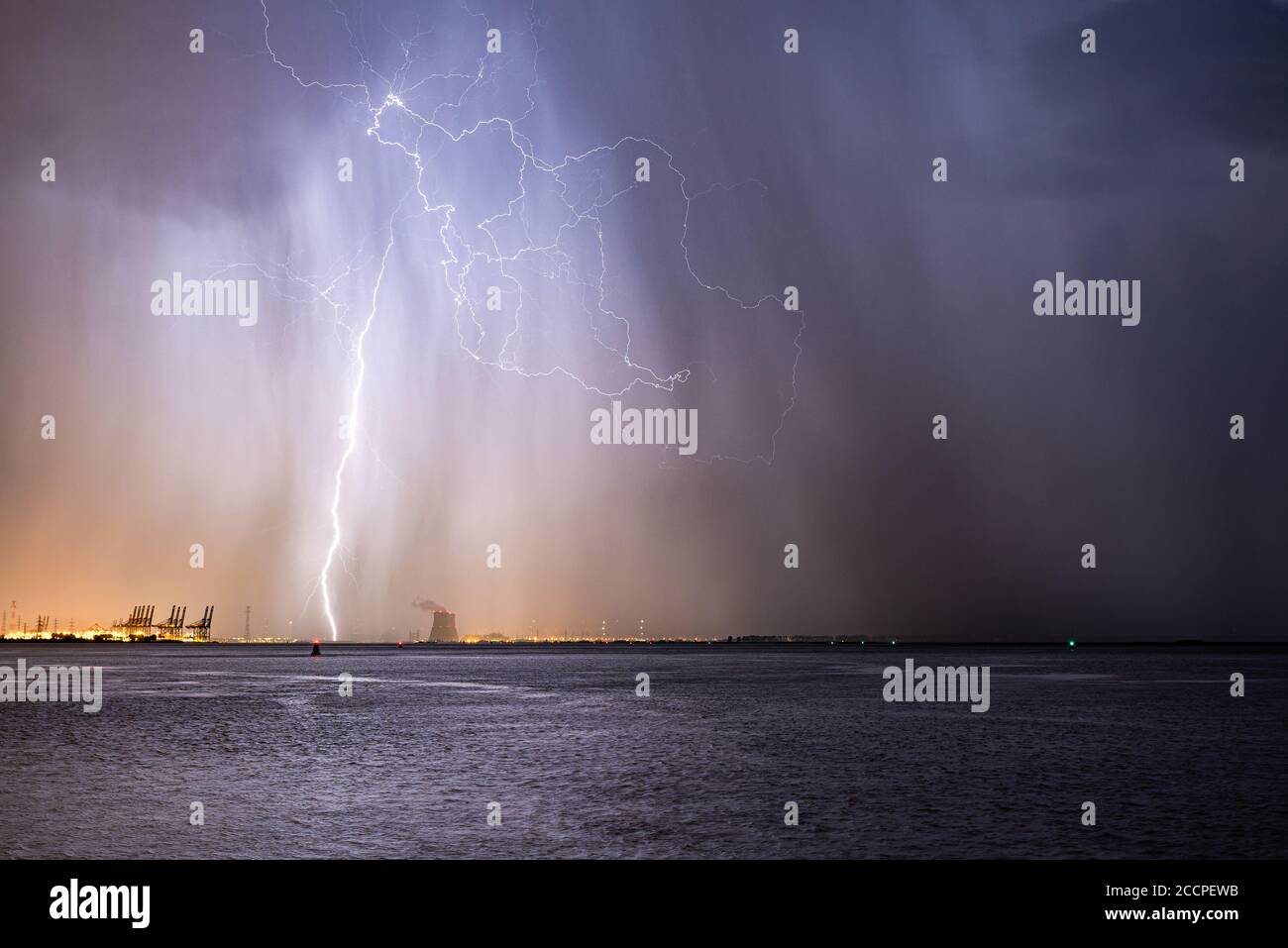 Fierce bolt of lightning strikes close to a nuclear power plant Stock ...