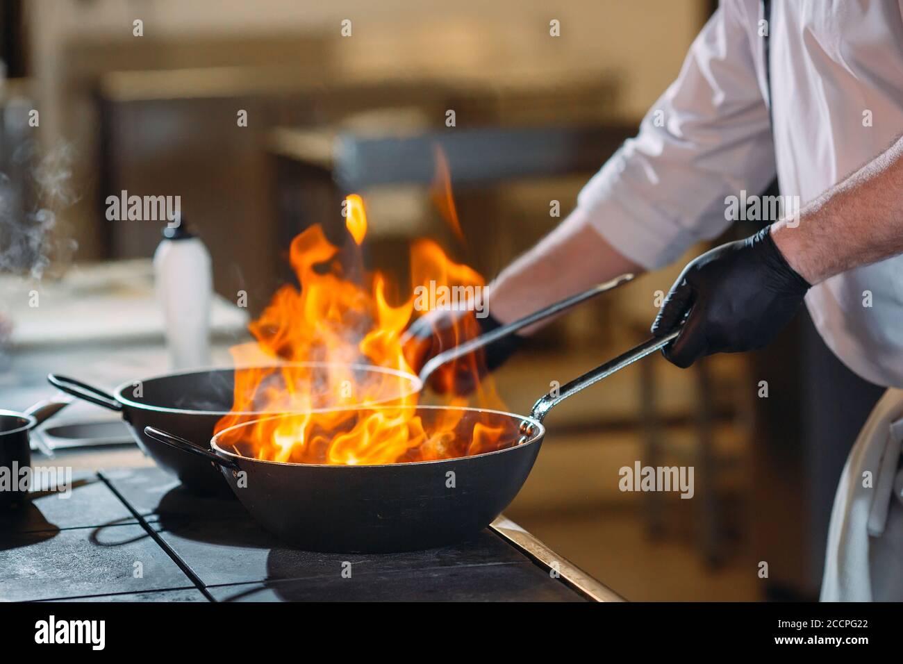 Modern kitchen. Cooks prepare meals on the stove in the kitchen of the ...