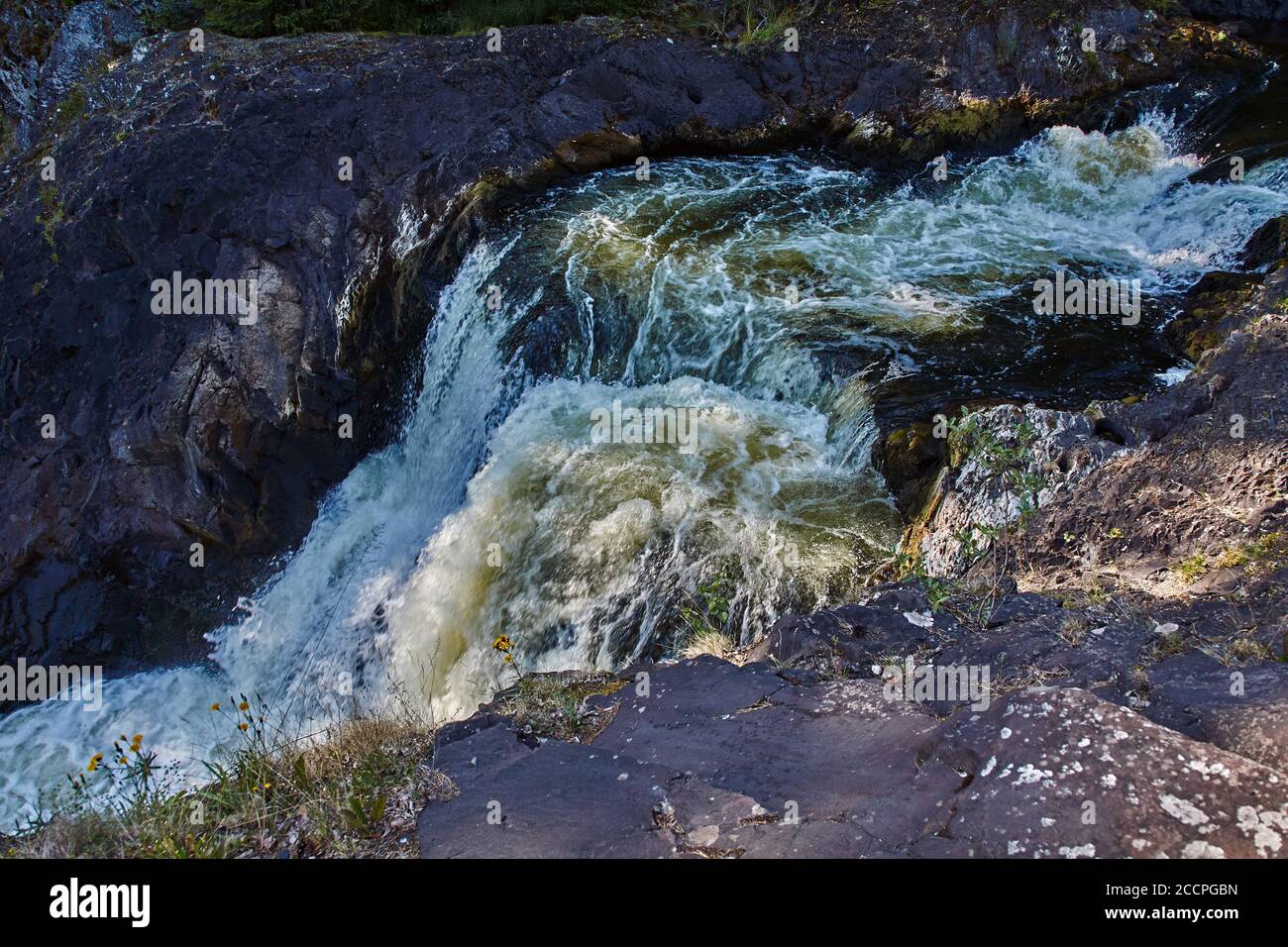 Long multistage flat waterfall. Seething waves and water falling on ...