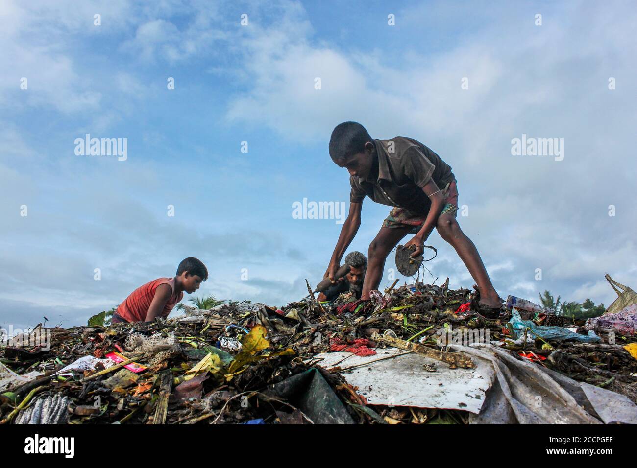 Koye, the biggest garbage dumpsite in Khulna. A Child is searching his ...