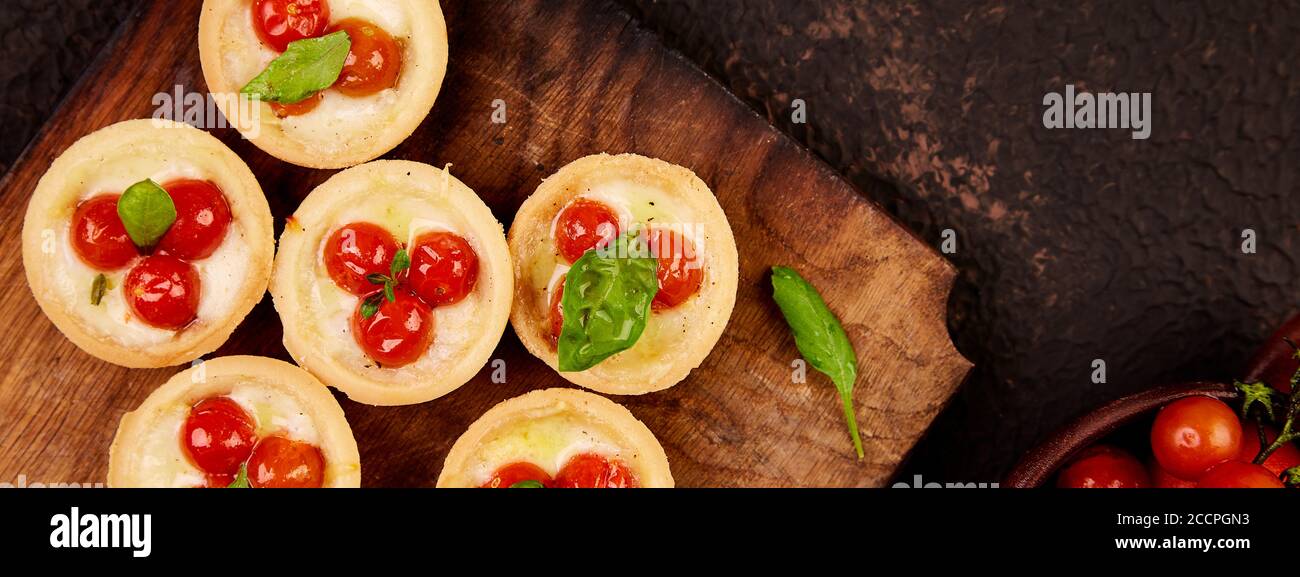 Banner of Mini tarts with cherry tomatoes with mozzarella cheese on ...