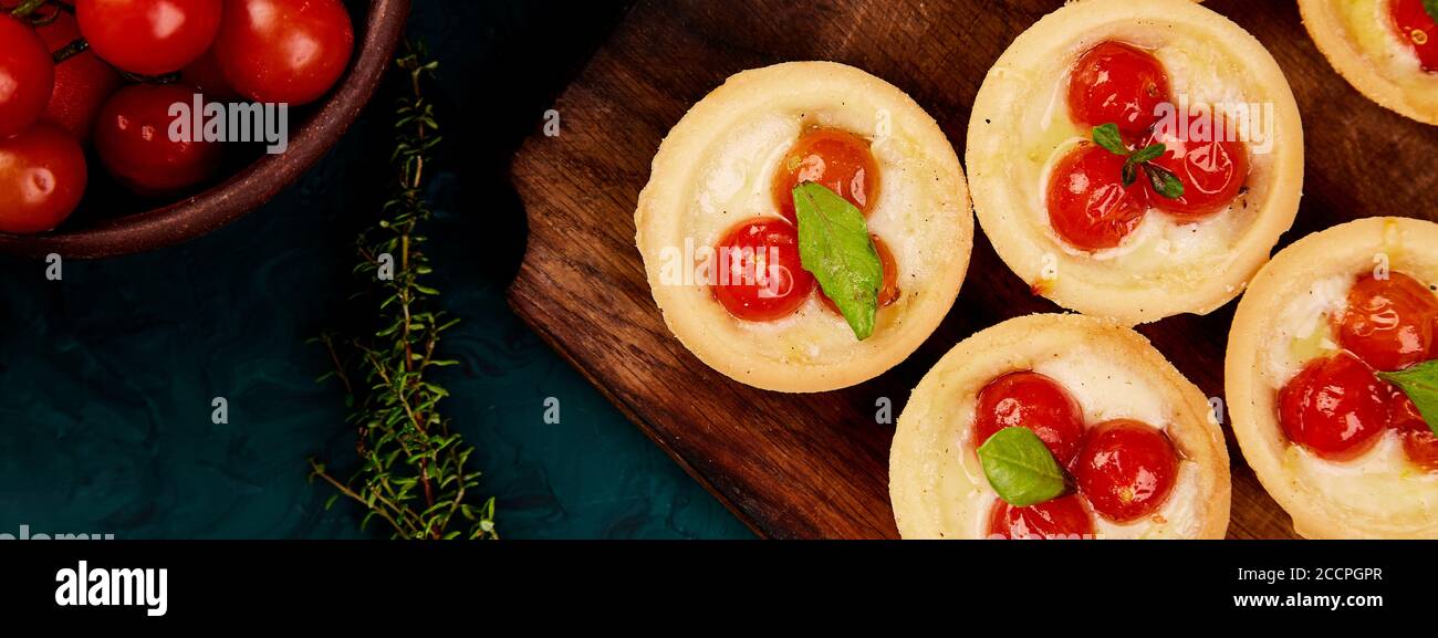 Banner of Mini tarts with cherry tomatoes with mozzarella cheese on ...