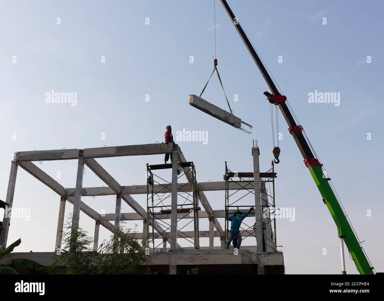 precast concrete beam installed at construction site by mobile crane ...