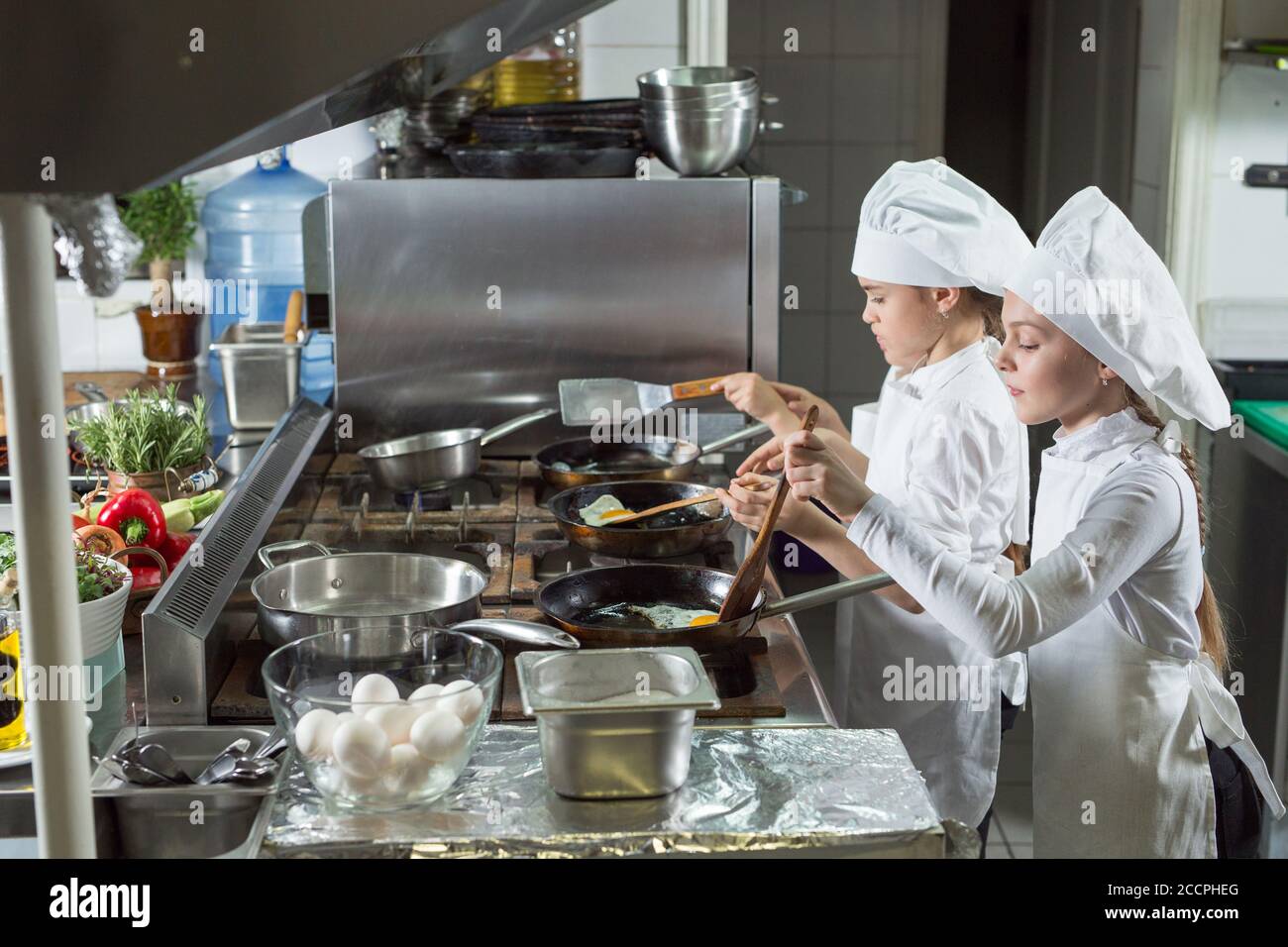 Children cook eggs in the kitchen at the Restaurant Stock Photo - Alamy