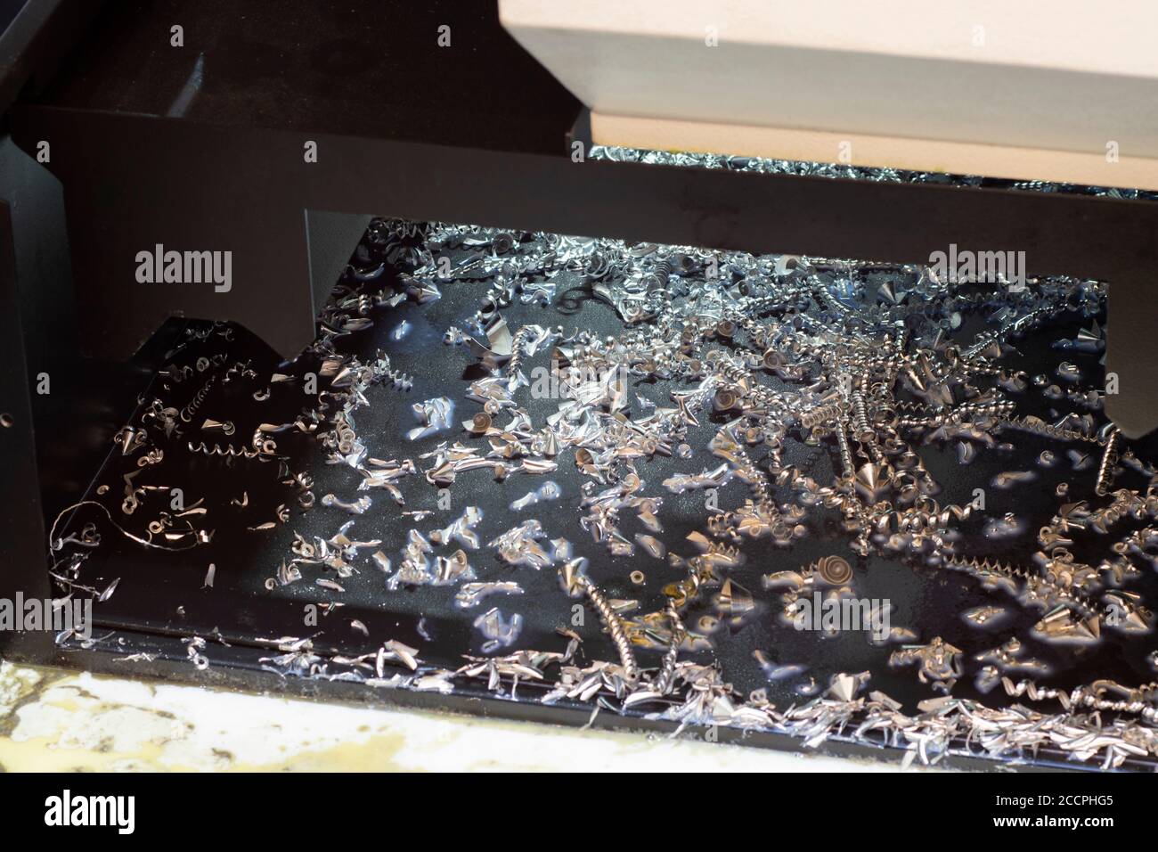 aluminium metal chip mixed with coolant exit from CNC machining process ...