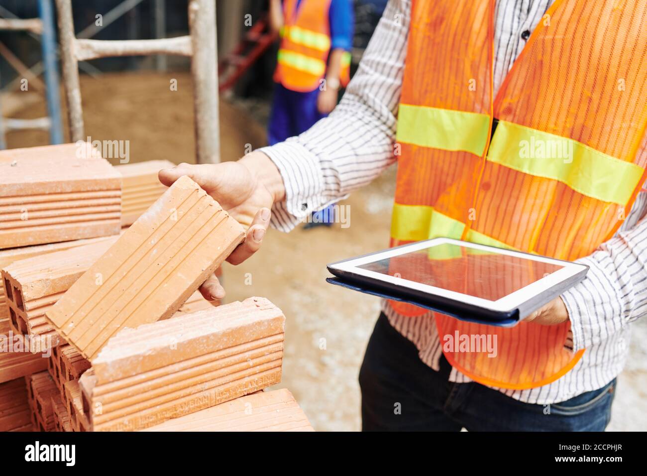 Close-up image of construction engineer reading list of building ...