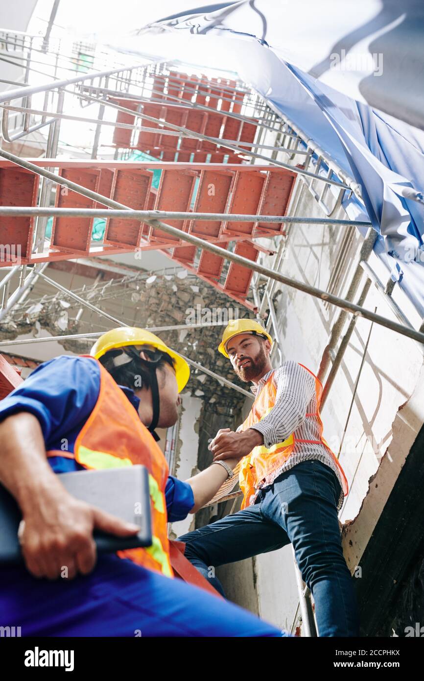 Helping coworker hi-res stock photography and images - Alamy