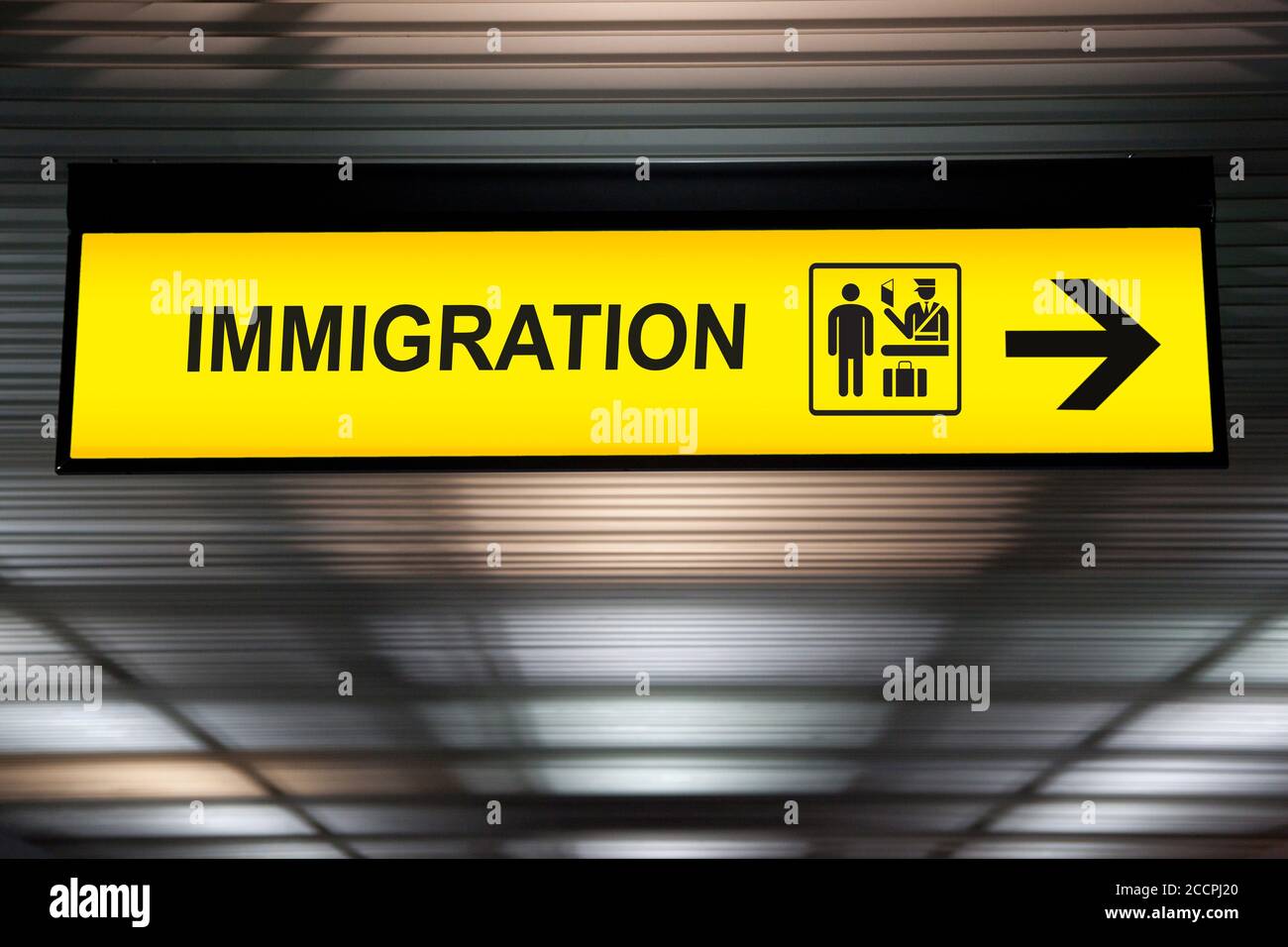 Airport immigration and customs sign hanging from the ceiling at the ...