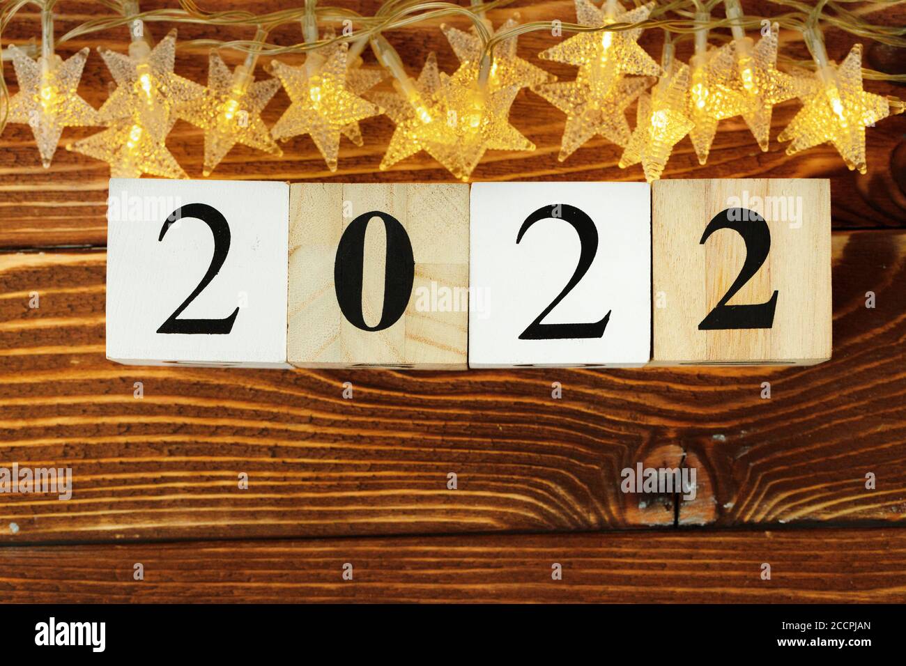 Concept of the year 2022. Golden stars and numbers 2022 on paper ...