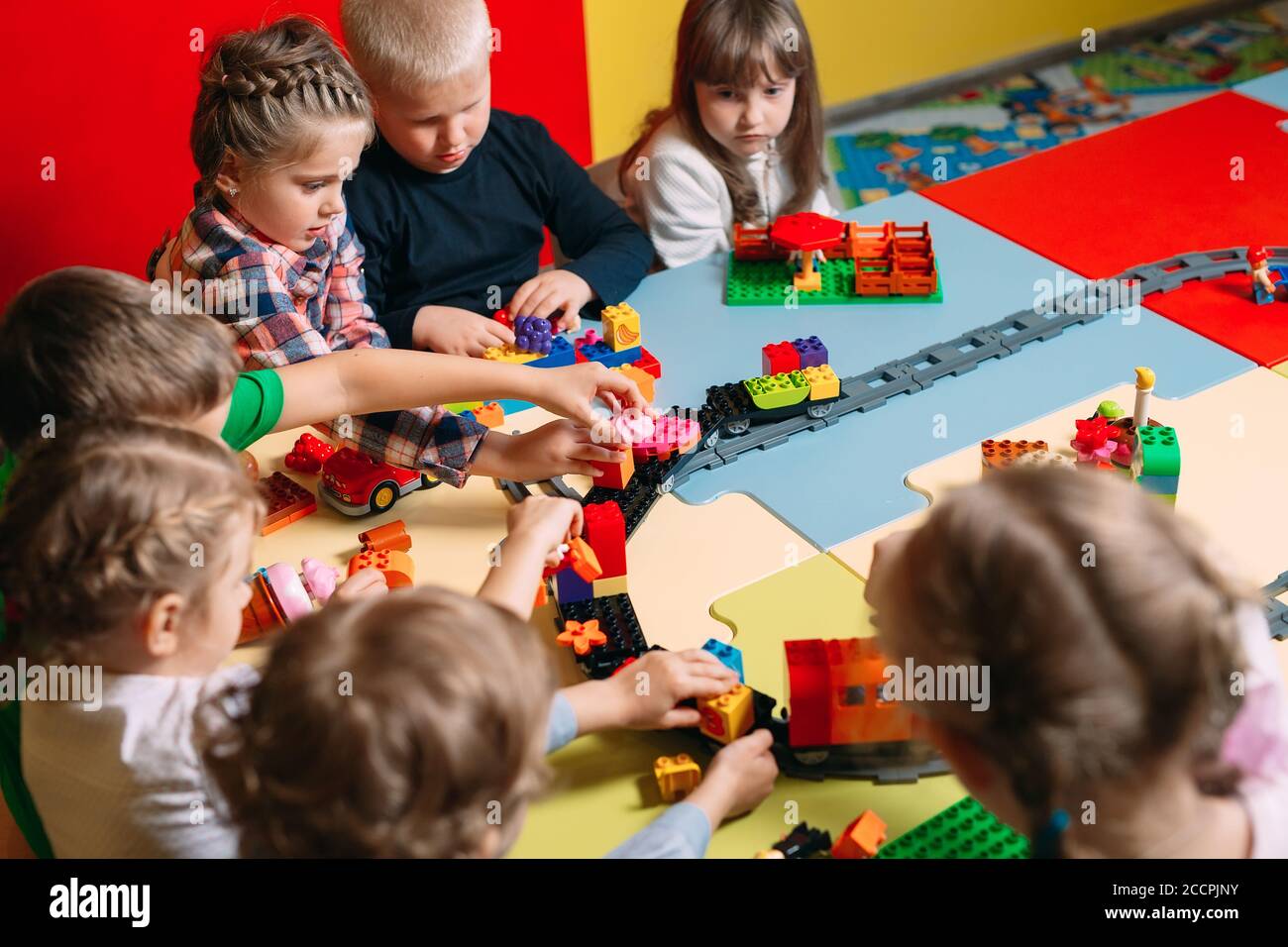 Teacher and children playing blocks hi-res stock photography and images ...