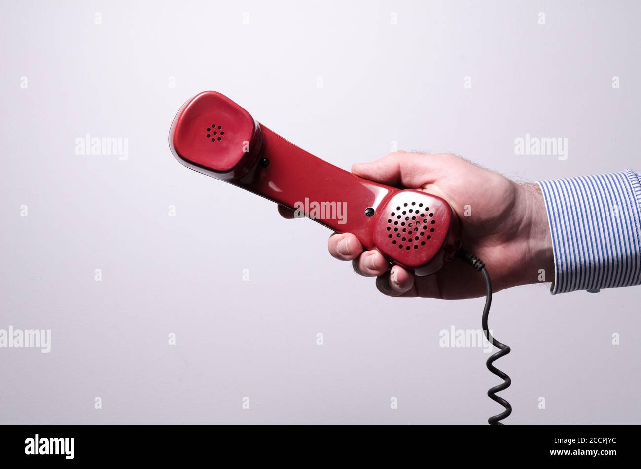 Hand holding landline phone hi-res stock photography and images - Alamy
