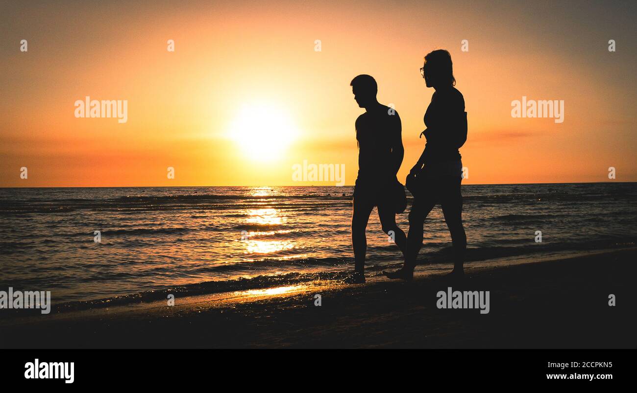 couple at the sunset beach Stock Photo - Alamy