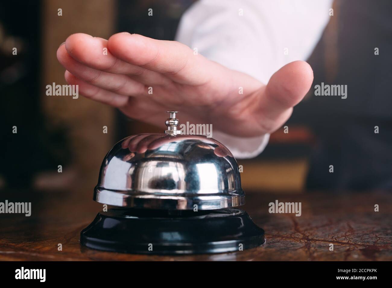 Restaurant bell vintage with hand. Hotel service bell Stock Photo - Alamy