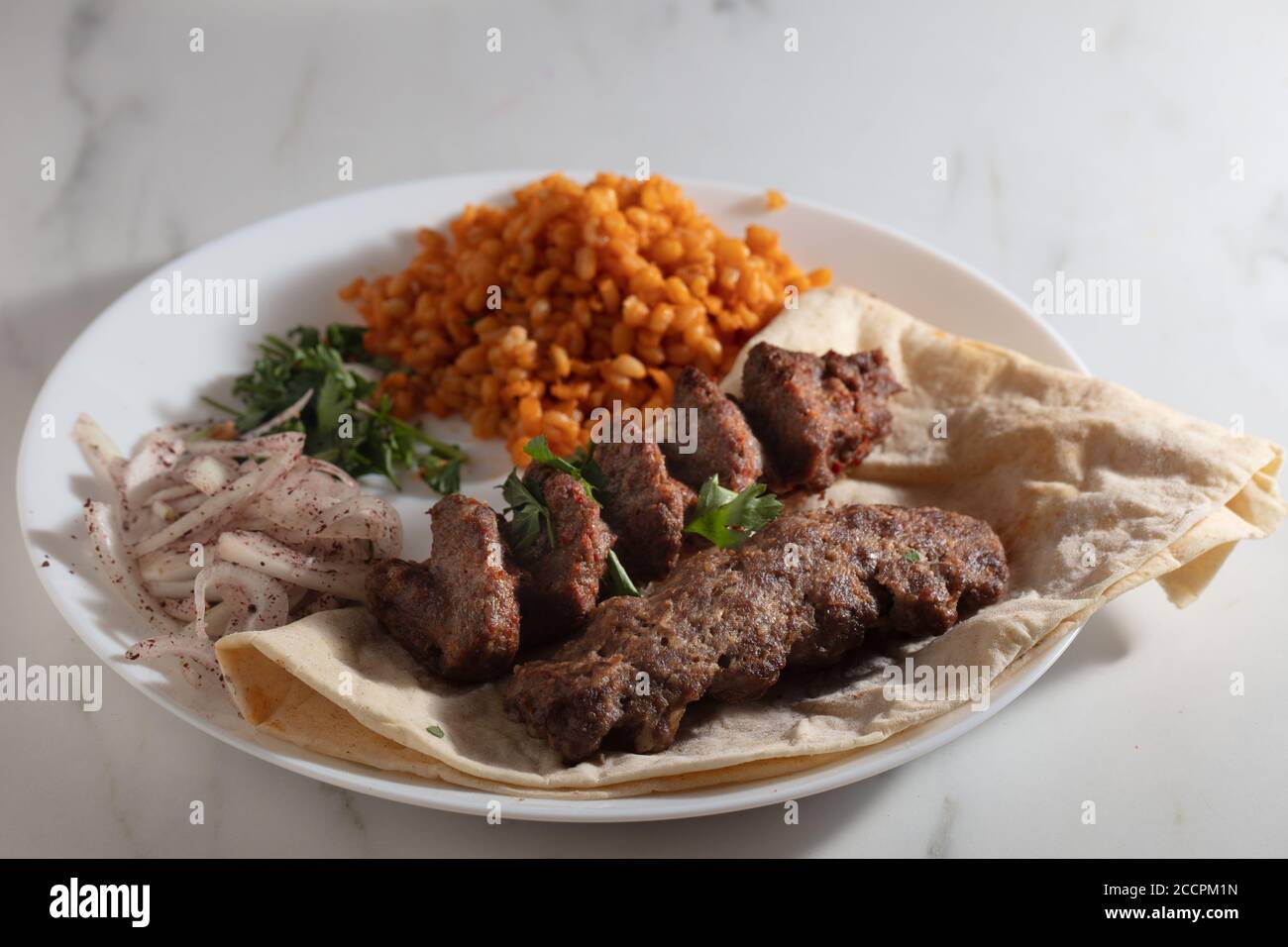 Traditional Adana Kebap with salad Stock Photo - Alamy