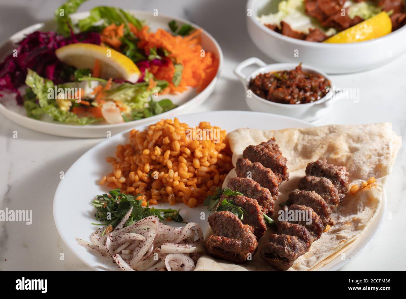 Traditional Adana Kebap with salad Stock Photo - Alamy