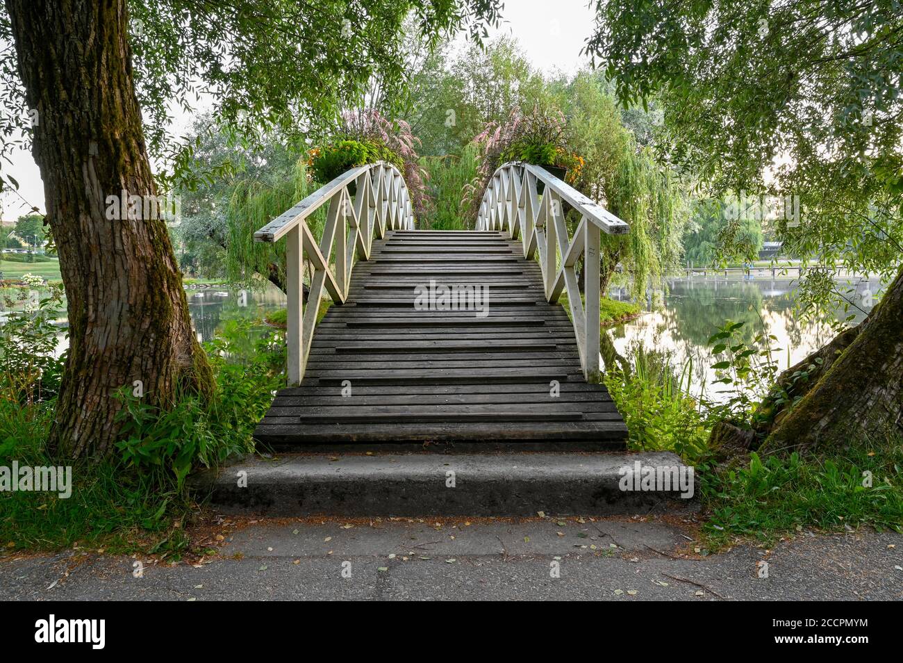 wooden bridge over water in beautiful park Stock Photo - Alamy