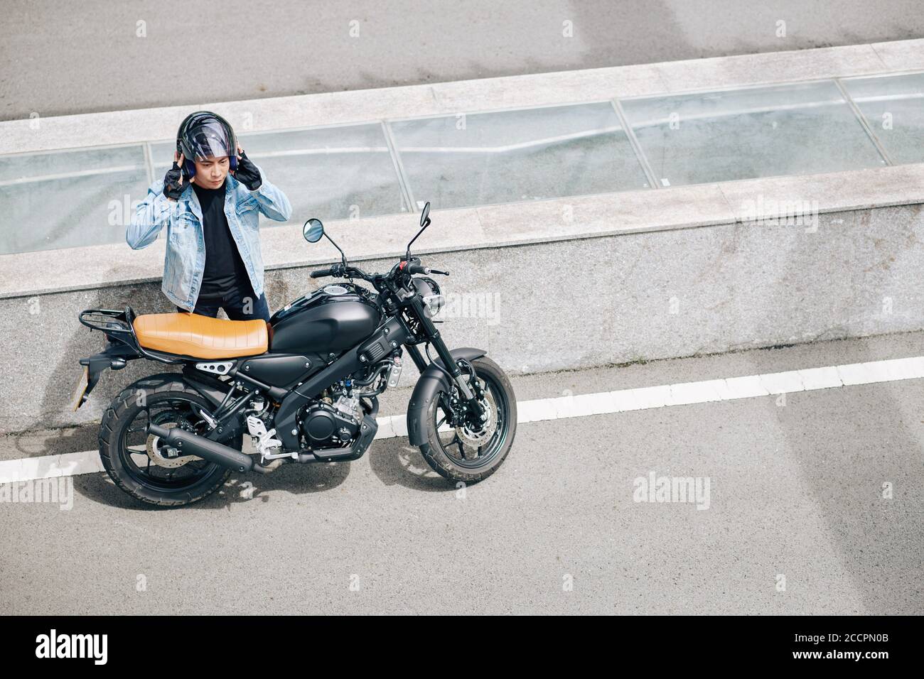 Taking off helmet hi-res stock photography and images - Alamy