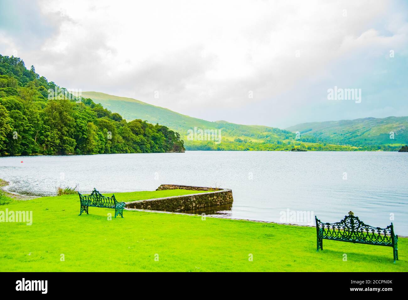 Empty benches on the shore of lake ullswater with beautiful view of the ...