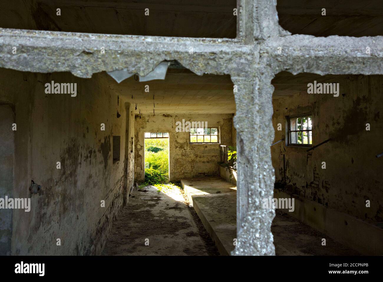 Inside of abandoned building seen through a broken glass window ...