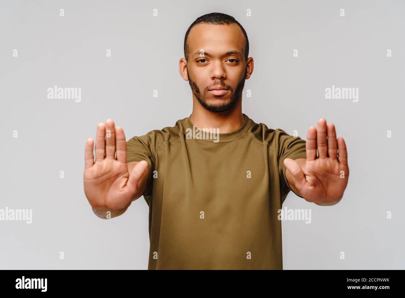 african american young man gesturing STOP with his hand over light grey ...