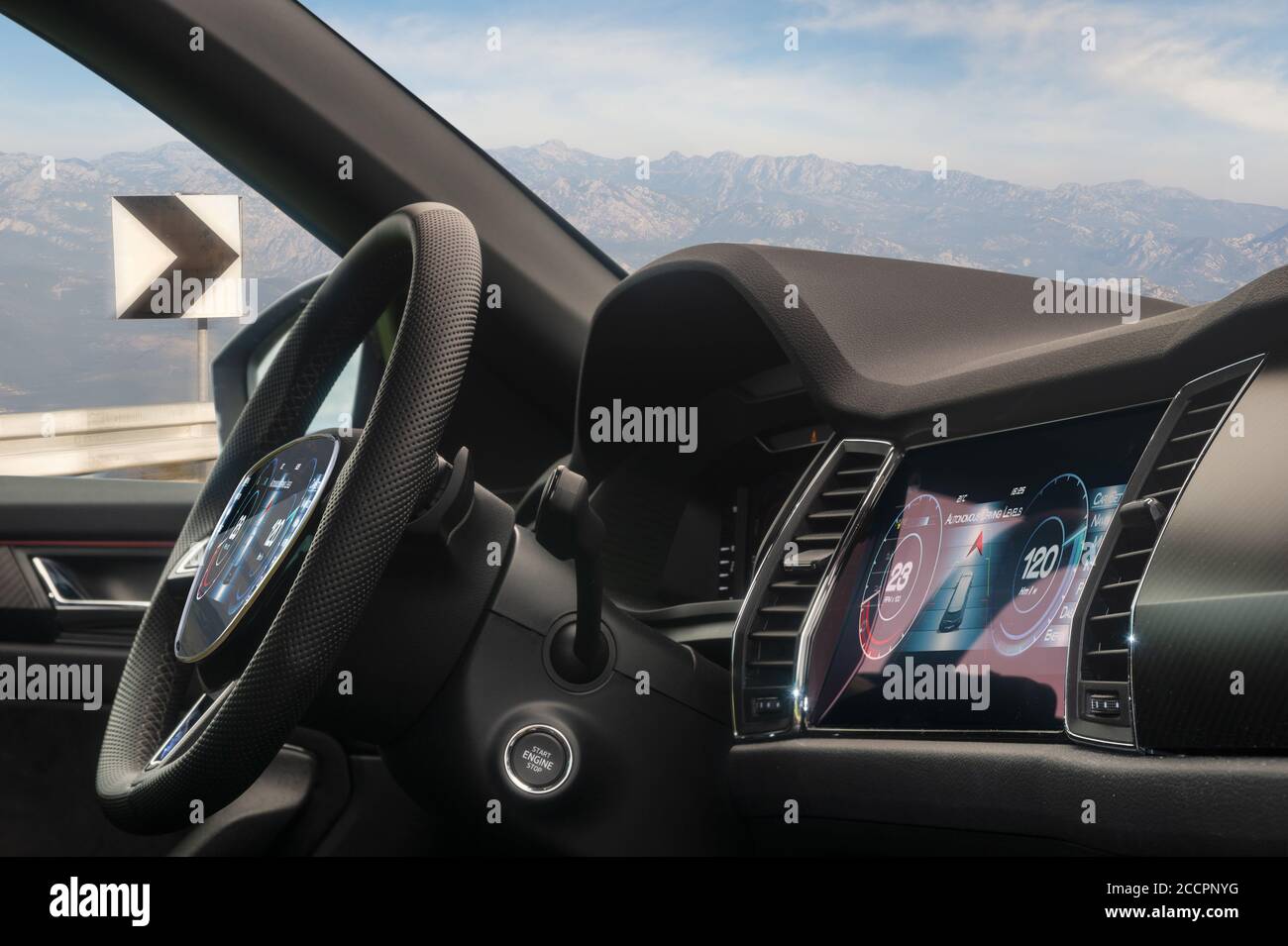 interior of a modern car with displays on the dashboard and steering ...