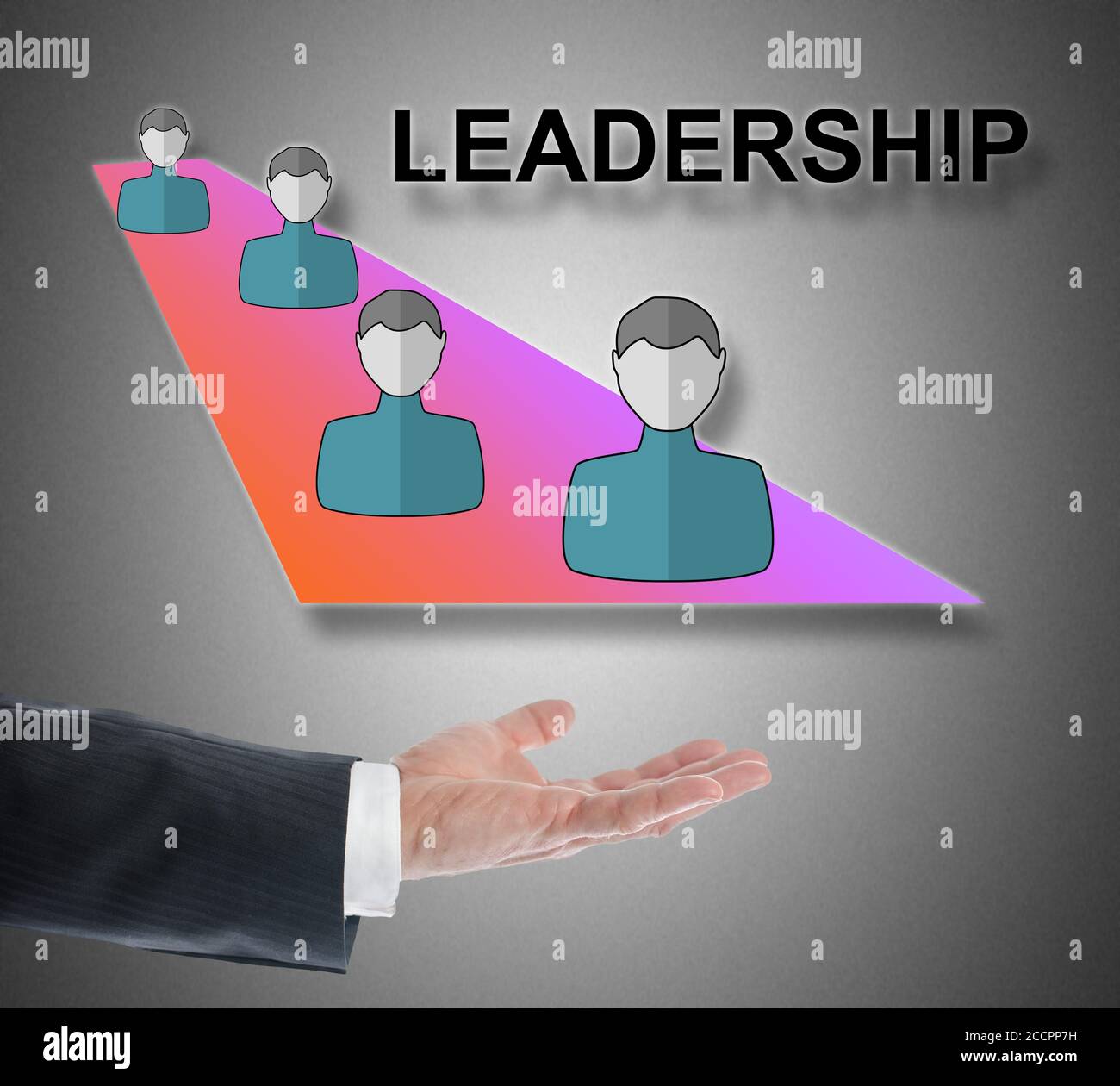 Leadership concept levitating above a hand on grey background Stock ...