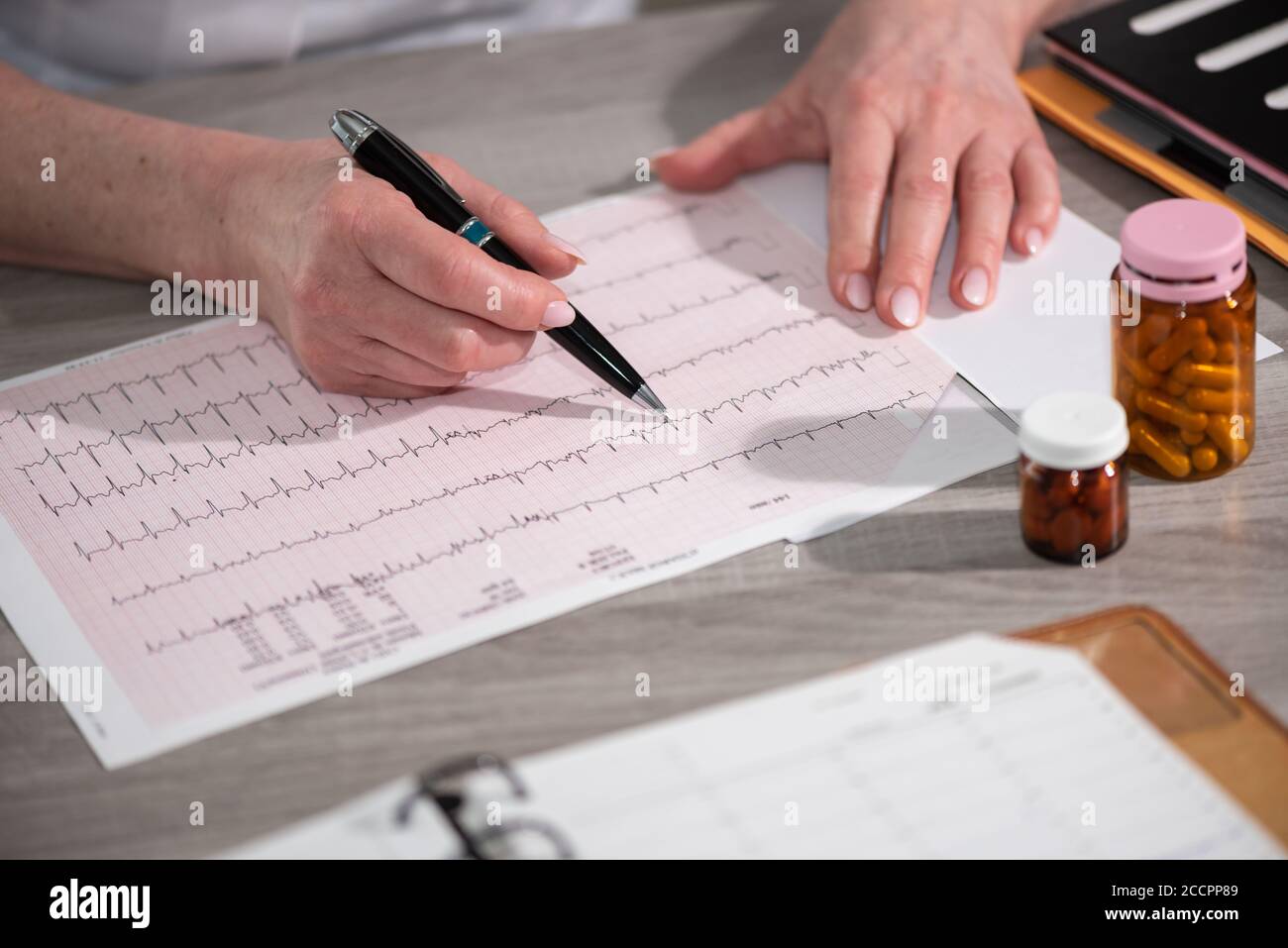 Female cardiologist examining an ecg graph in medical office Stock ...