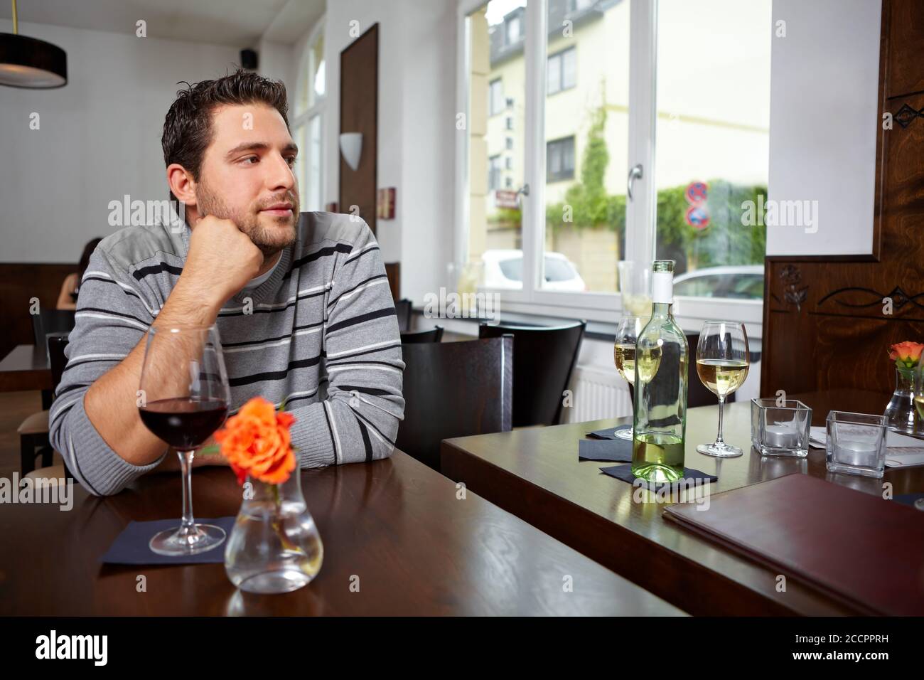 Man waiting alone in the restaurant with wine Stock Photo - Alamy