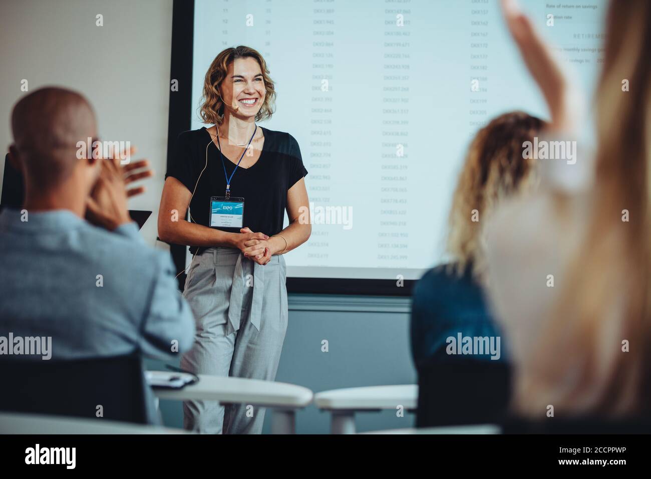Team of professionals clapping hands in a meeting for a female ...