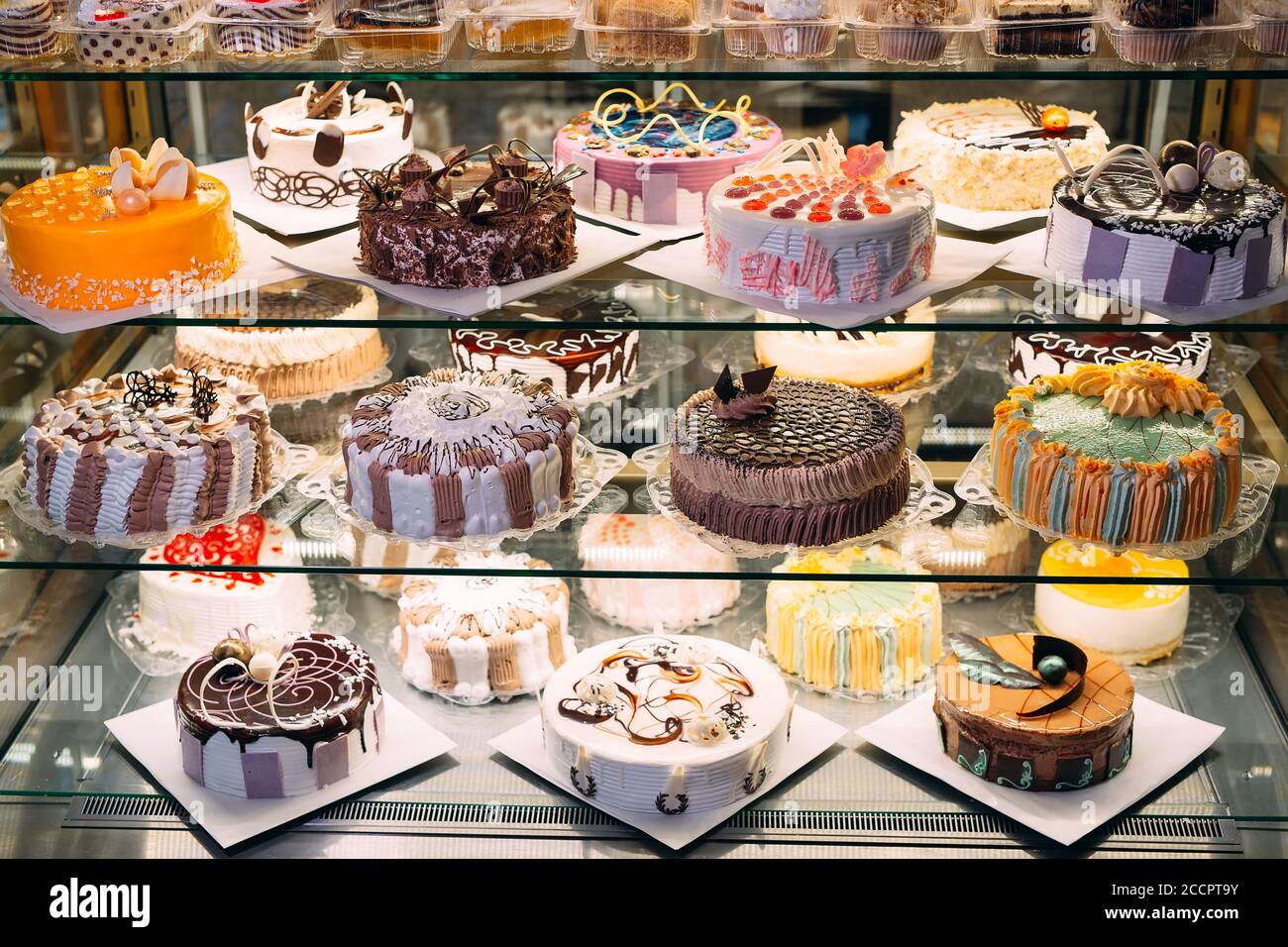 Pastry shop glass display with selection of cream or fruit cake Stock ...