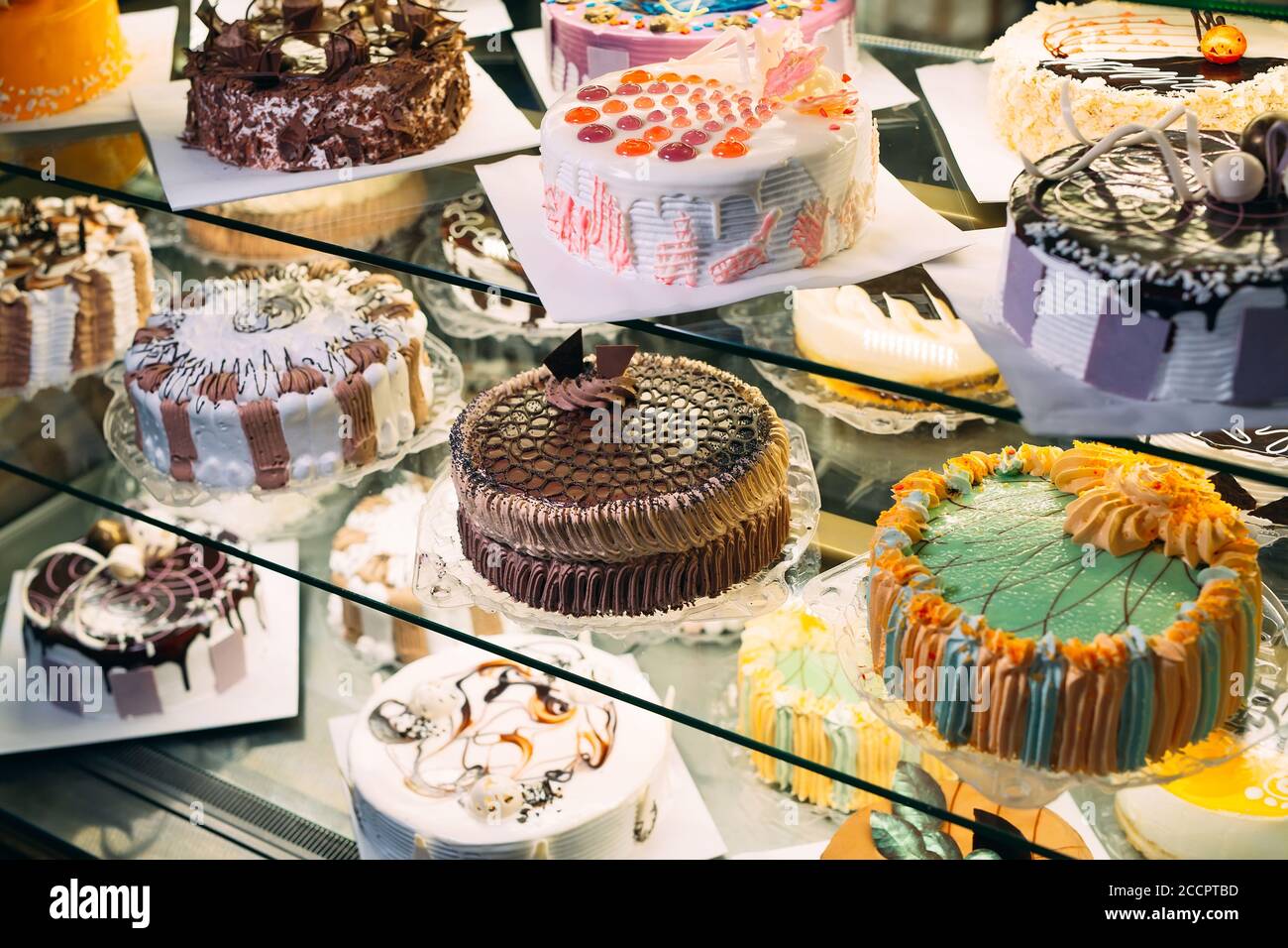 Pastry shop glass display with selection of cream or fruit cake Stock ...
