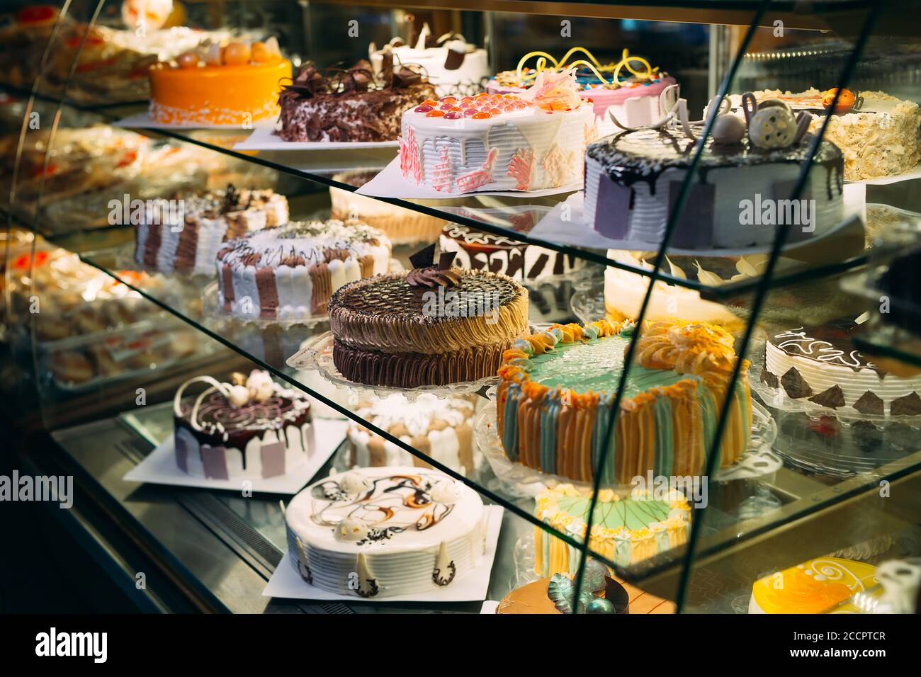 Pastry shop glass display with selection of cream or fruit cake Stock ...