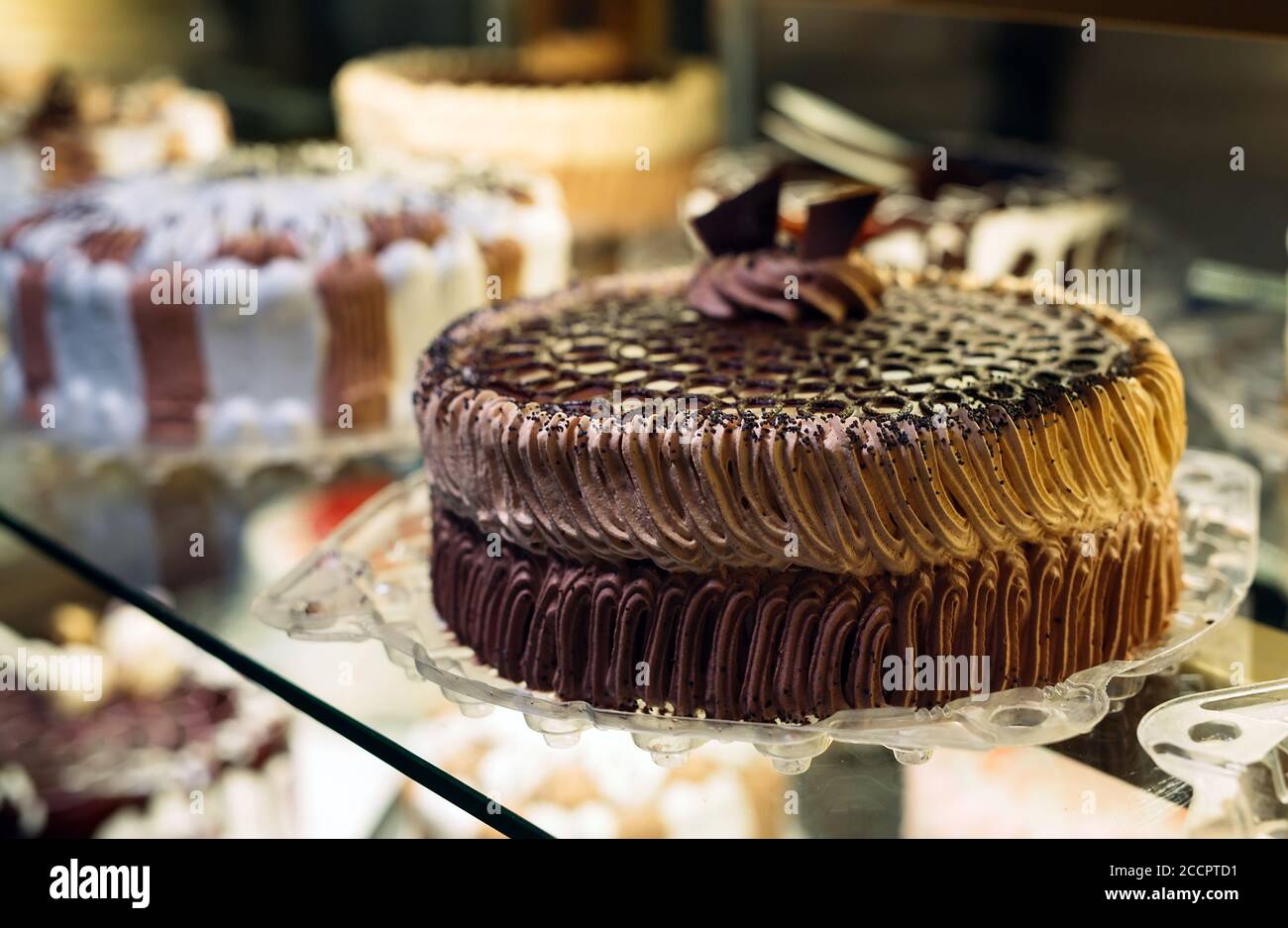 Pastry shop glass display with selection of cream or fruit cake Stock ...