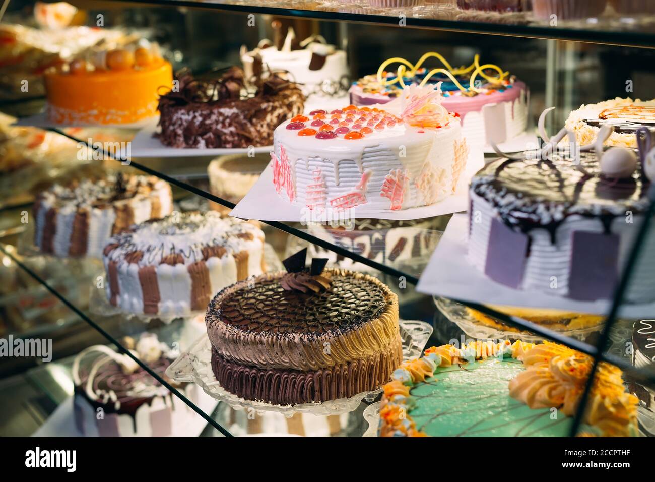 Pastry shop glass display with selection of cream or fruit cake Stock ...