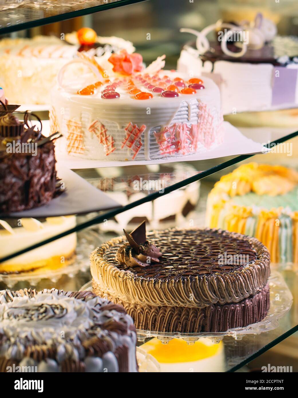 Pastry shop glass display with selection of cream or fruit cake Stock ...