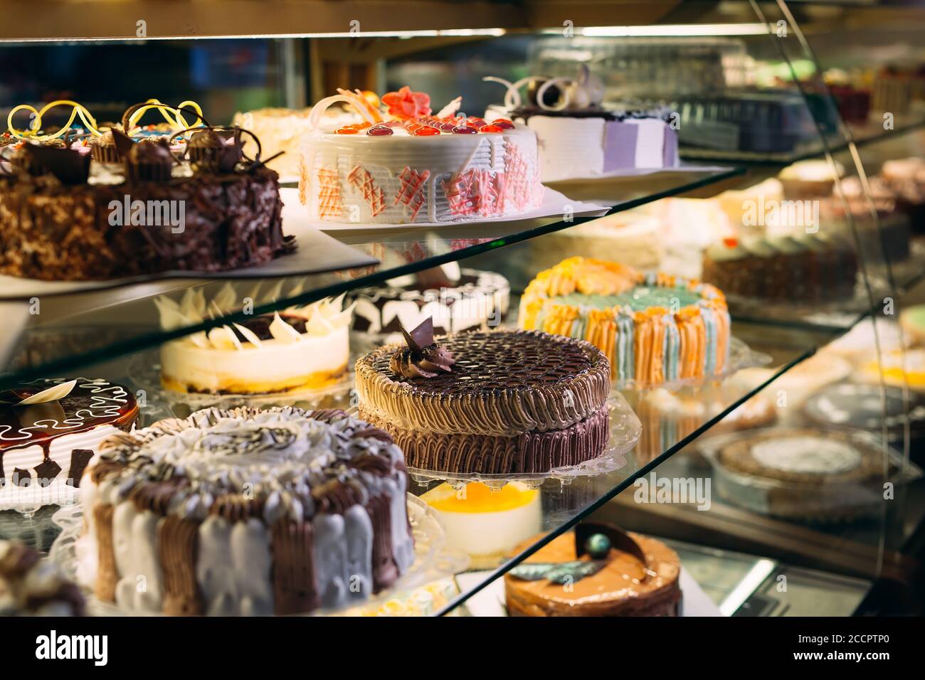 Pastry shop glass display with selection of cream or fruit cake Stock ...