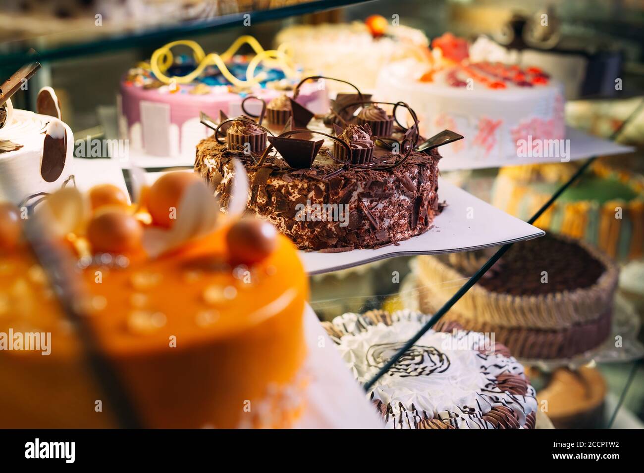 Pastry shop glass display with selection of cream or fruit cake Stock ...