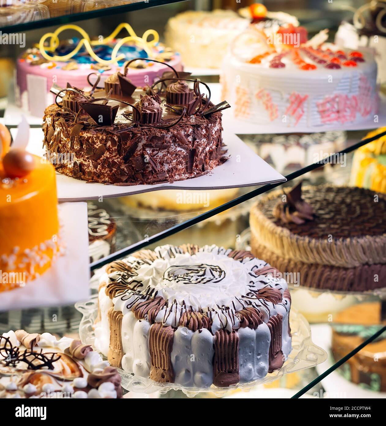 Pastry shop glass display with selection of cream or fruit cake Stock ...