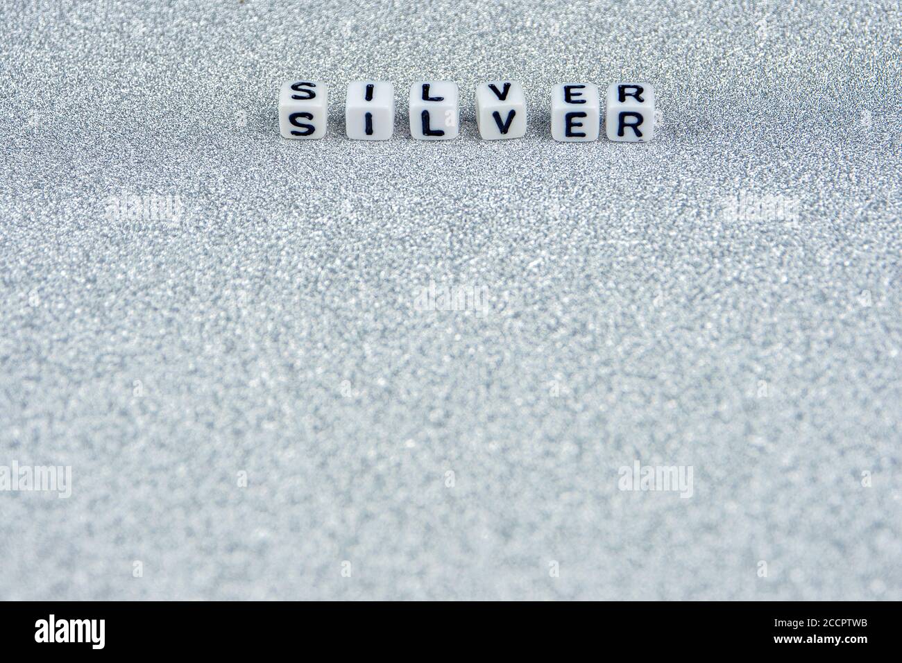 silver word formed by white dices with black letters laying in upper ...