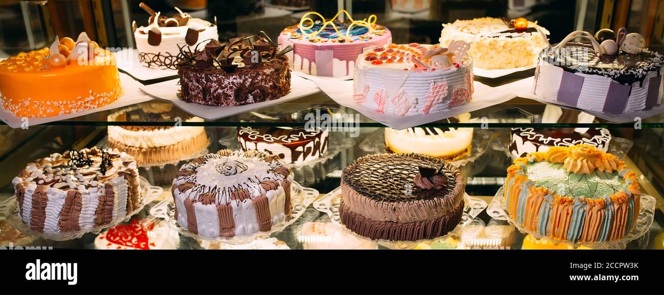 Pastry shop glass display with selection of cream or fruit cake Stock ...