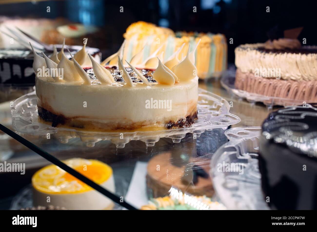 Pastry shop glass display with selection of cream or fruit cake Stock ...