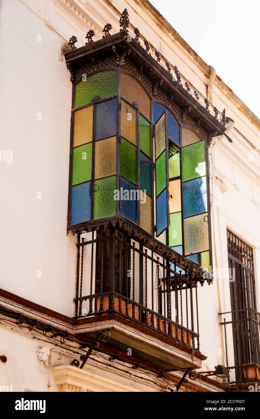 Iron finials top a stained glass window box in Cordoba, Spain Stock ...