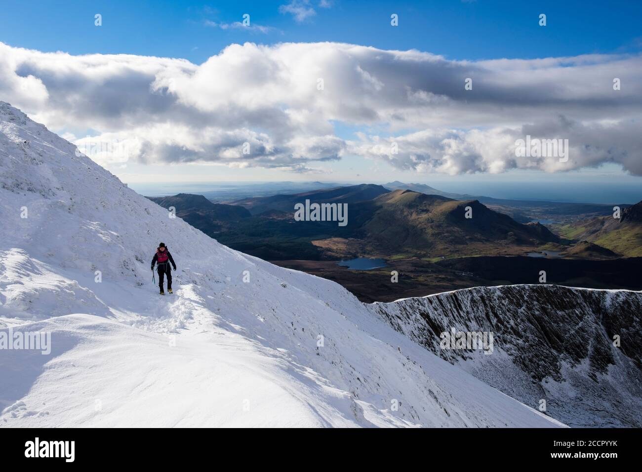 Hiker hiking on Rhyd Ddu path at Bwlch Main on Mt Snowdon with deep ...