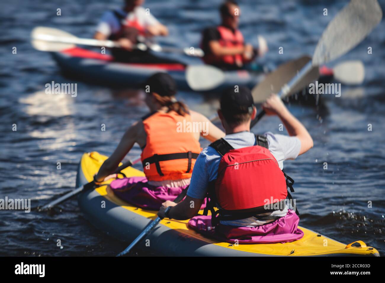 A process of kayaking in the city river canals, with colorful canoe ...