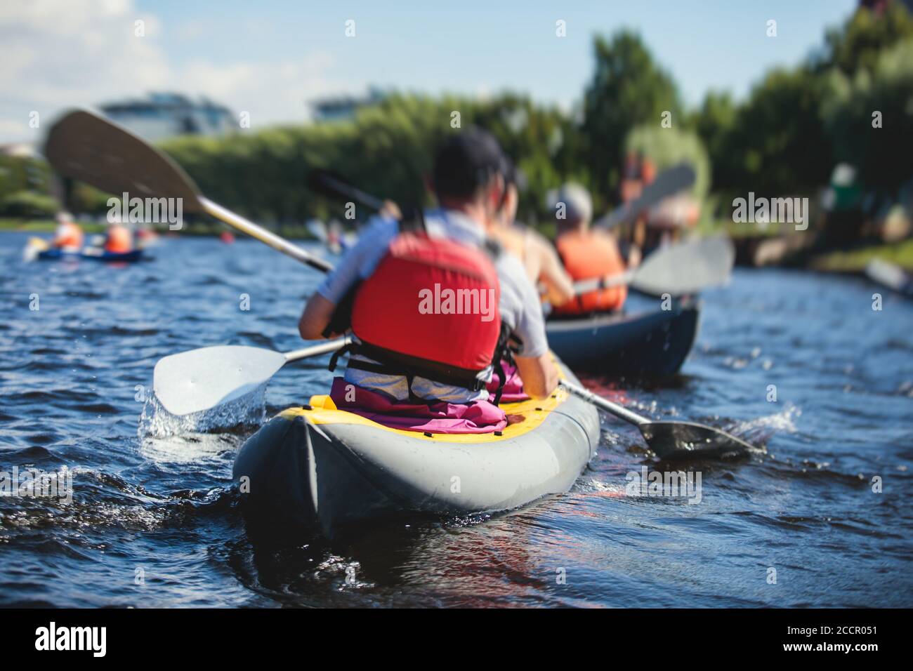 A process of kayaking in the city river canals, with colorful canoe ...