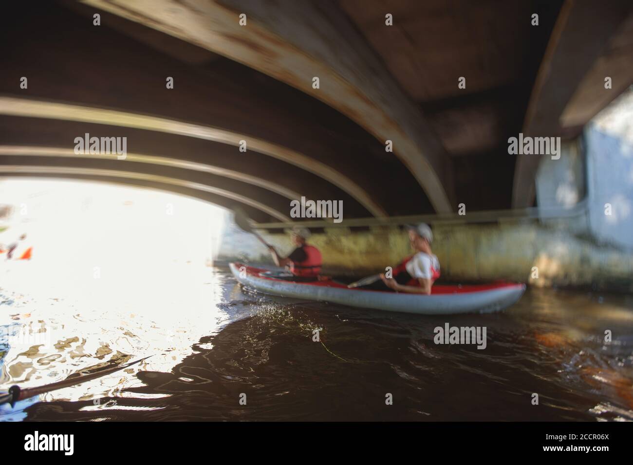 A process of kayaking in the city river canals, with colorful canoe ...